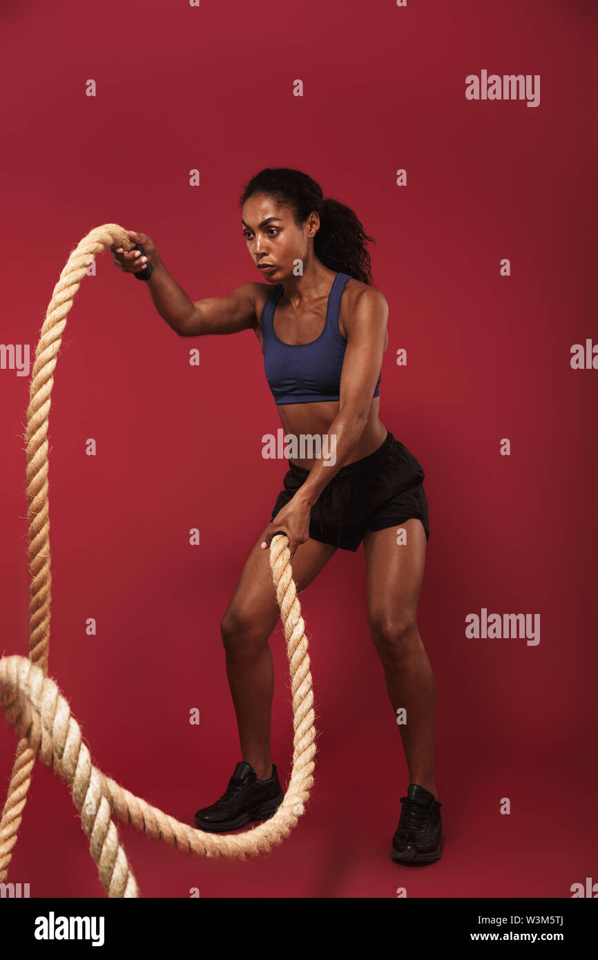 Image of a serious strong young african fitness sports woman posing ...
