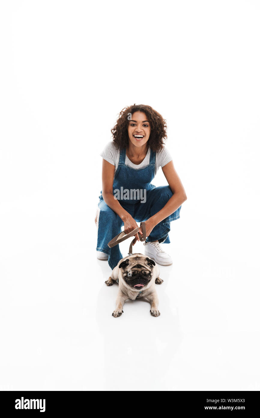 Image of delighted african american woman dressed in denim overalls ...