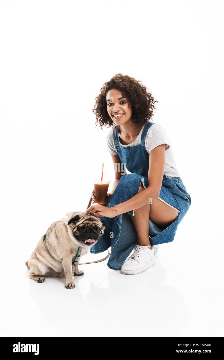 Image of adorable african american woman wearing denim overalls holding ...