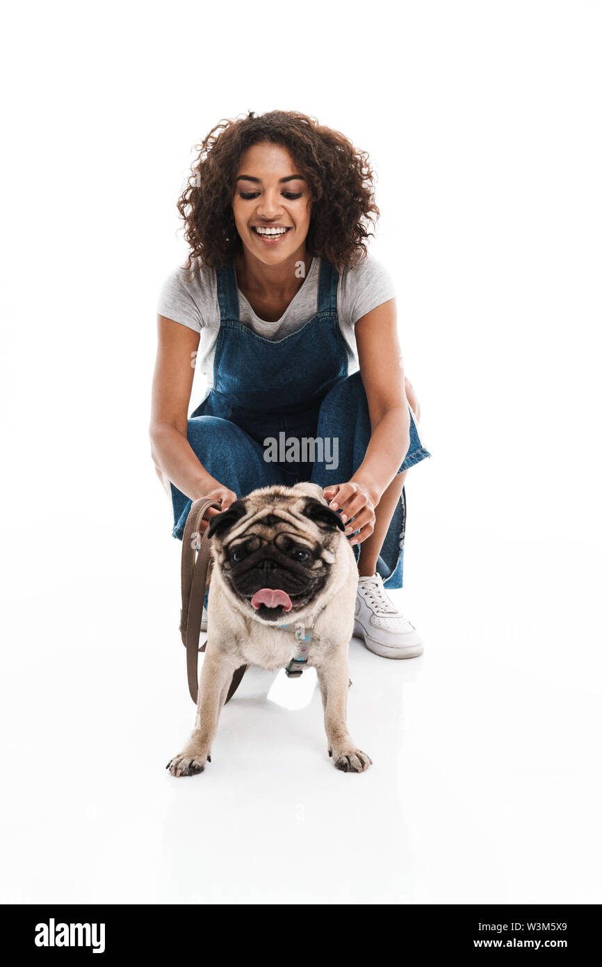Image of happy african american woman dressed in denim overalls ...