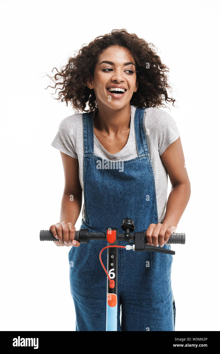 Image of cheery african american woman dressed in denim overalls ...