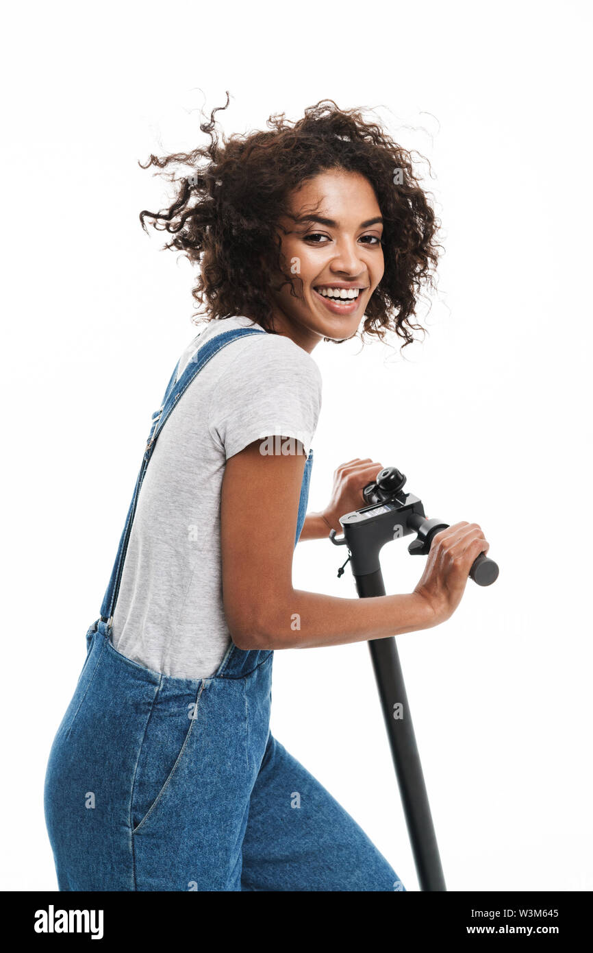 Image of positive african american woman dressed in denim overalls ...