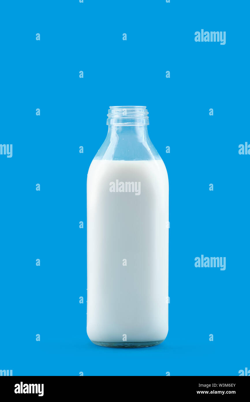 Open bottle of milk isolated on blue background Stock Photo - Alamy