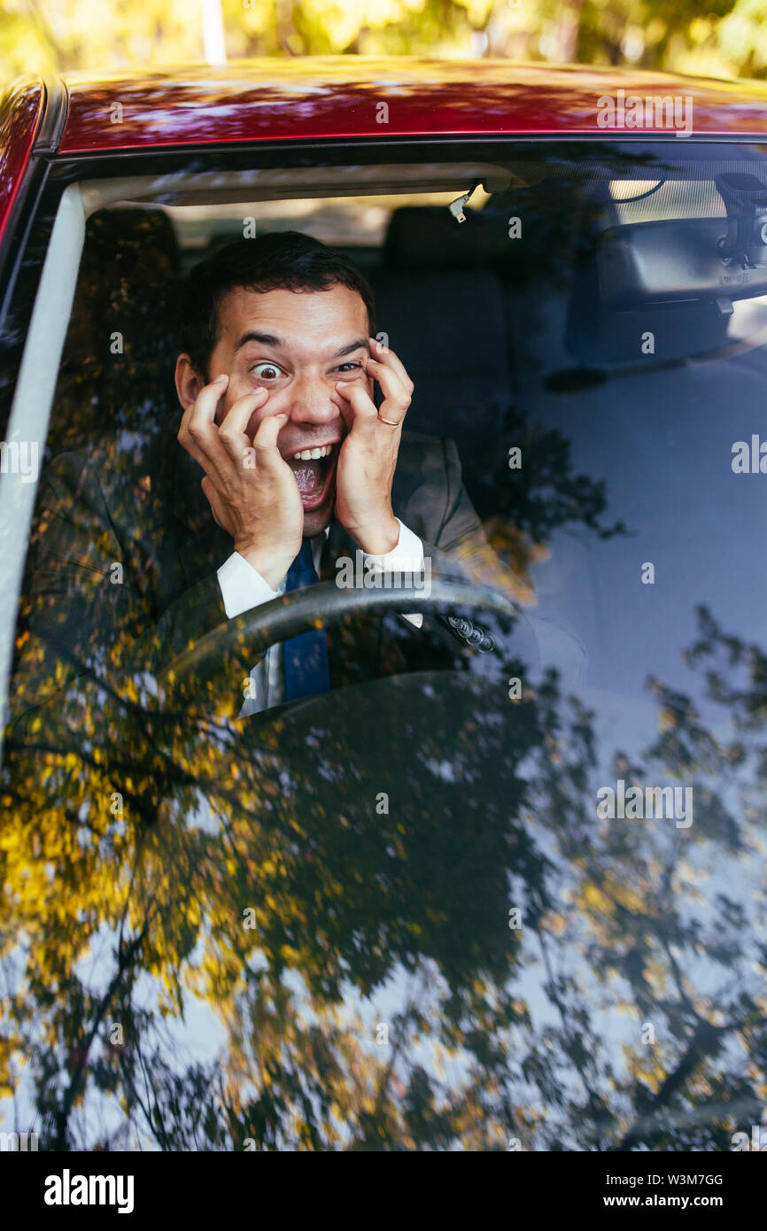 Shocked driver in the car, frightened man driving Stock Photo - Alamy