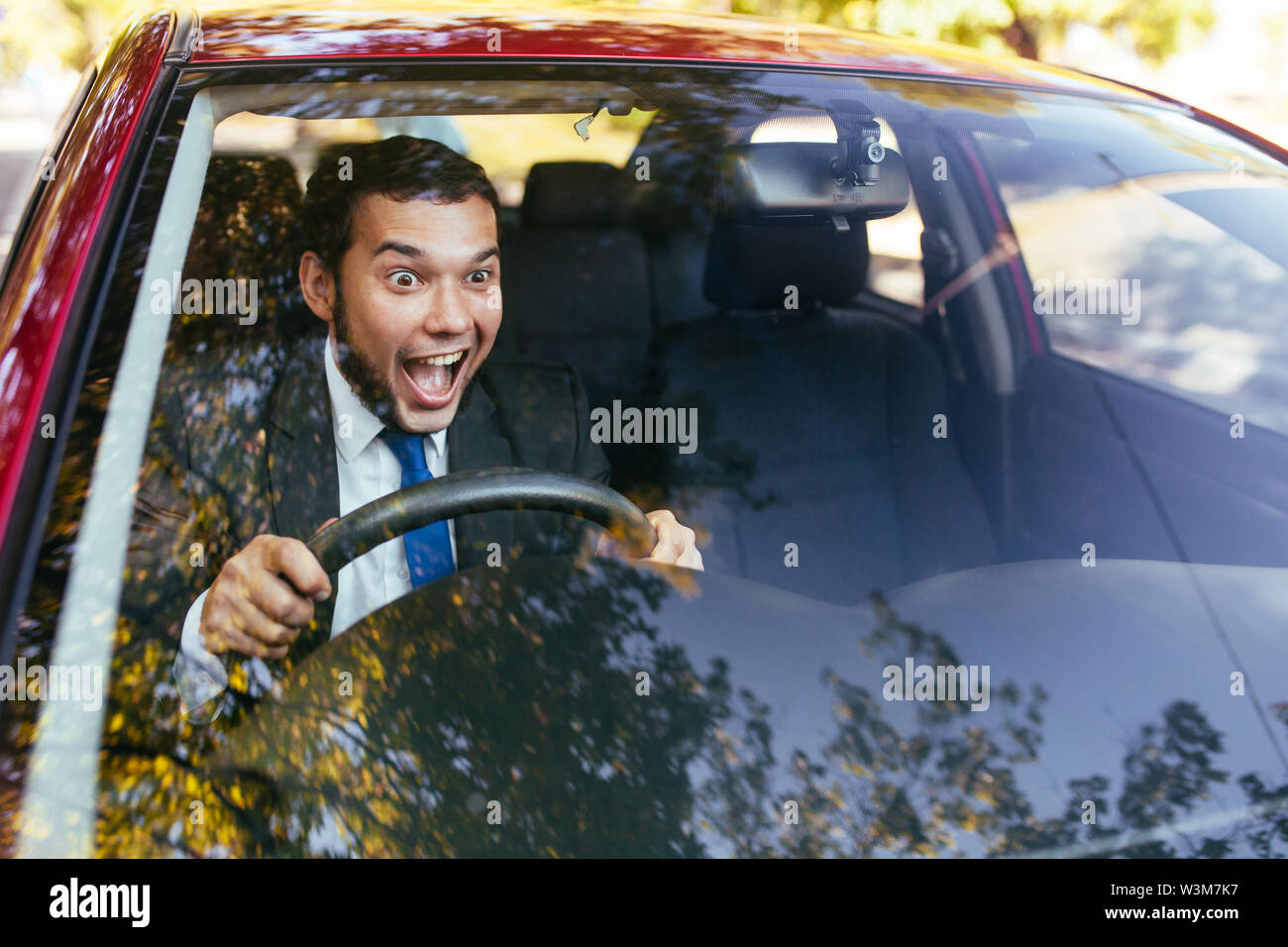 Shocked driver in the car, frightened man driving Stock Photo - Alamy