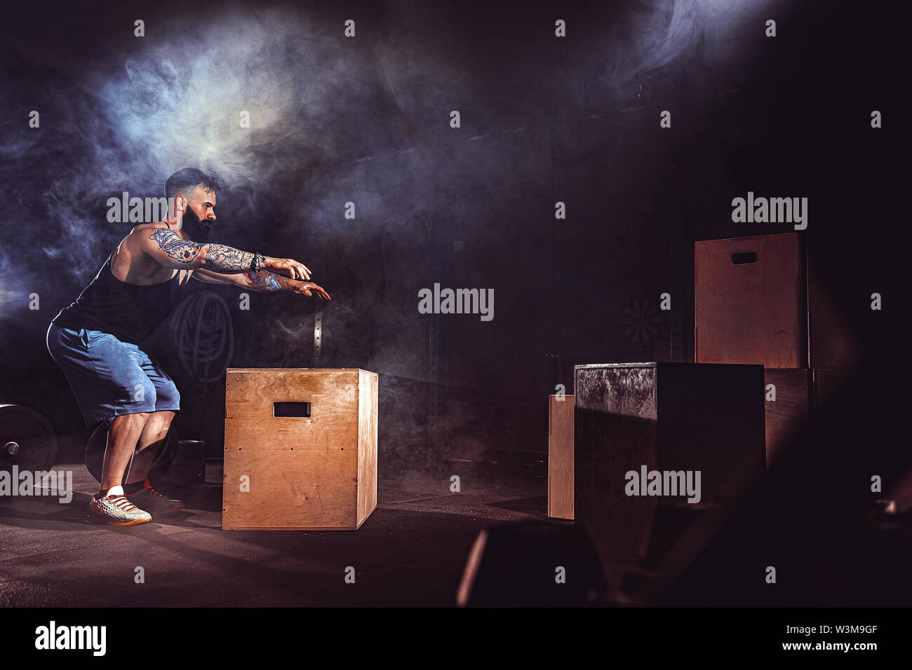 Athlete gave exercise. Jumping on the box. Phase touchdown. Gym shots ...