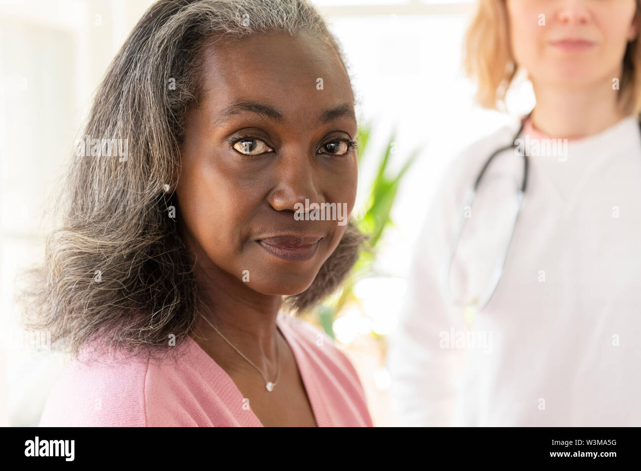 Mature woman and nurse Stock Photo - Alamy
