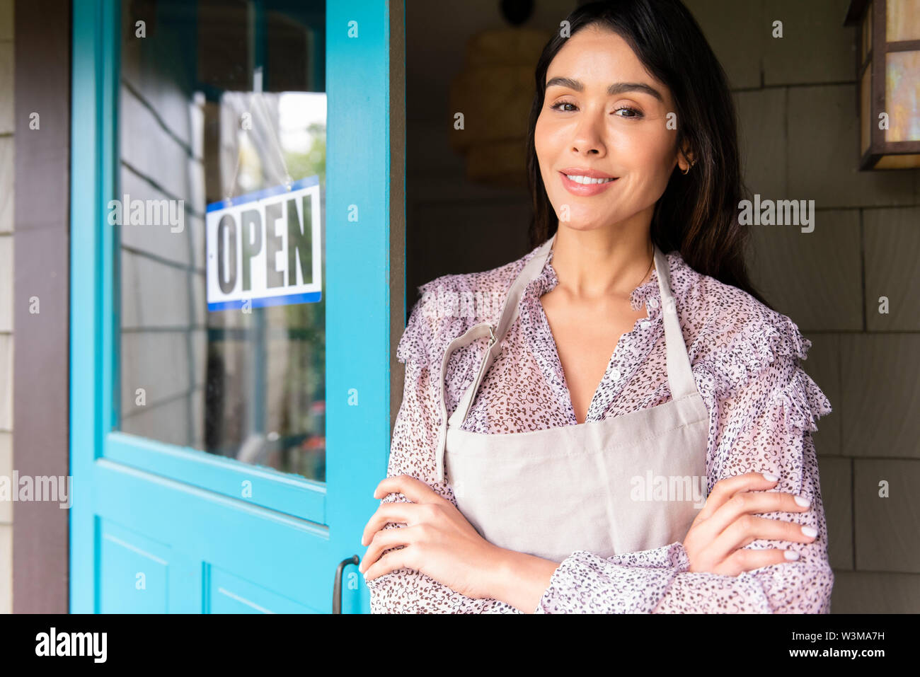Women hanging open sign hi-res stock photography and images - Alamy