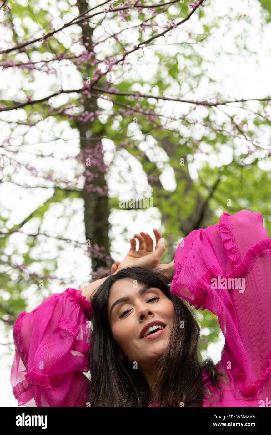 Woman under trees hi-res stock photography and images - Alamy