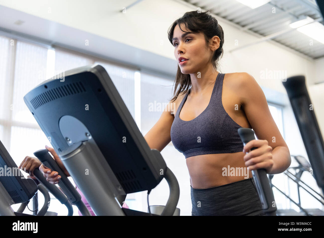 Woman exercising on machine hi-res stock photography and images - Alamy