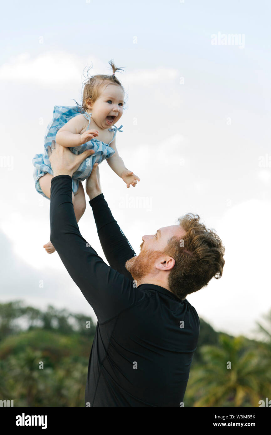 Man lifting baby daughter Stock Photo - Alamy
