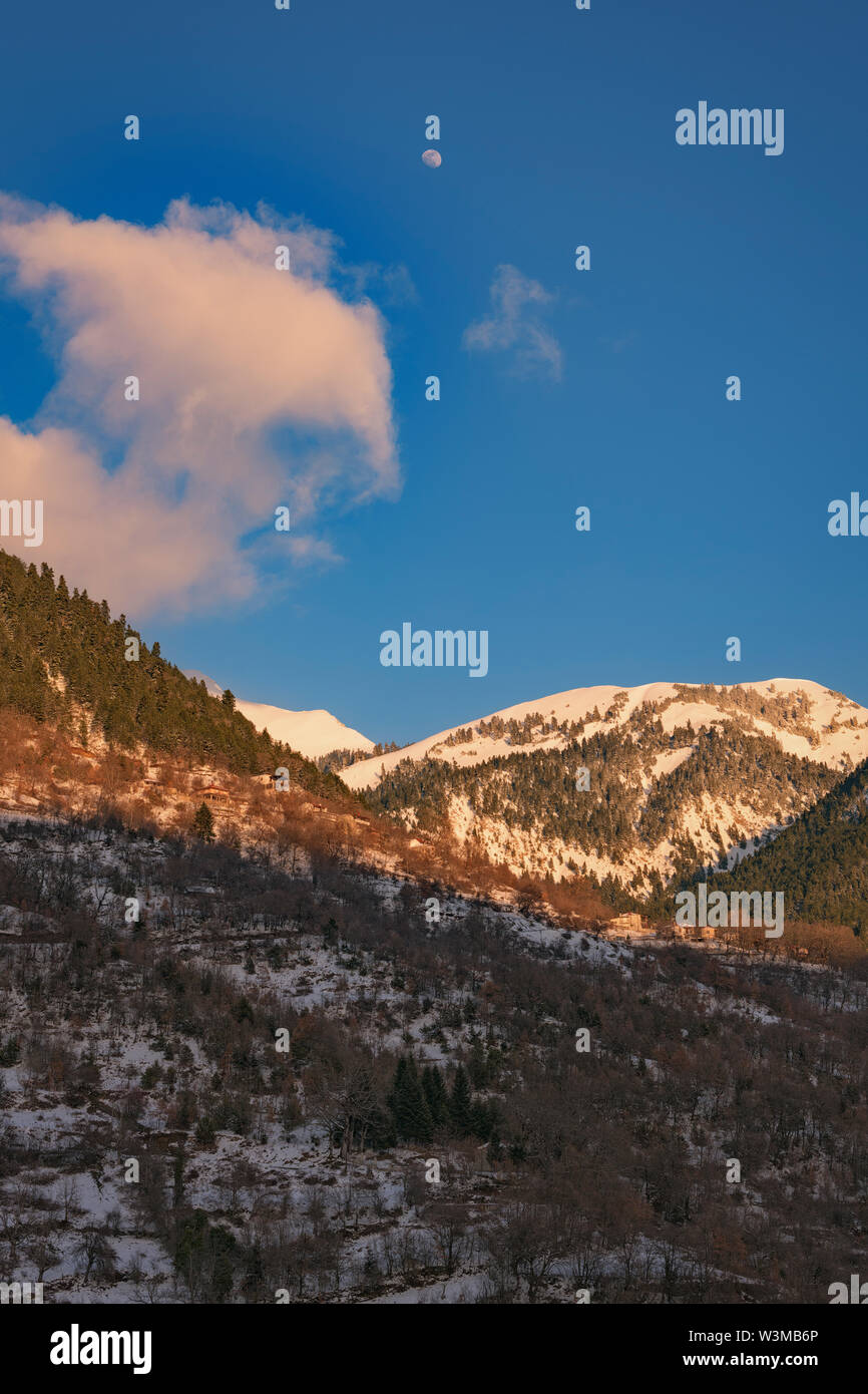 Moon Rising Above The Snowy Agrafa Mountains Stock Photo - Alamy