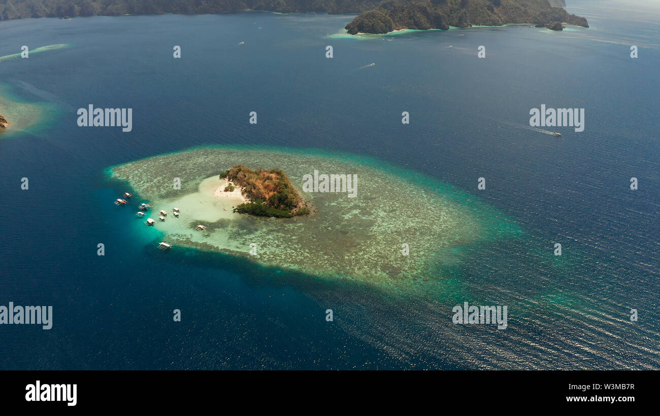 aerial view tropical island with sand white beach, clear and blue water ...