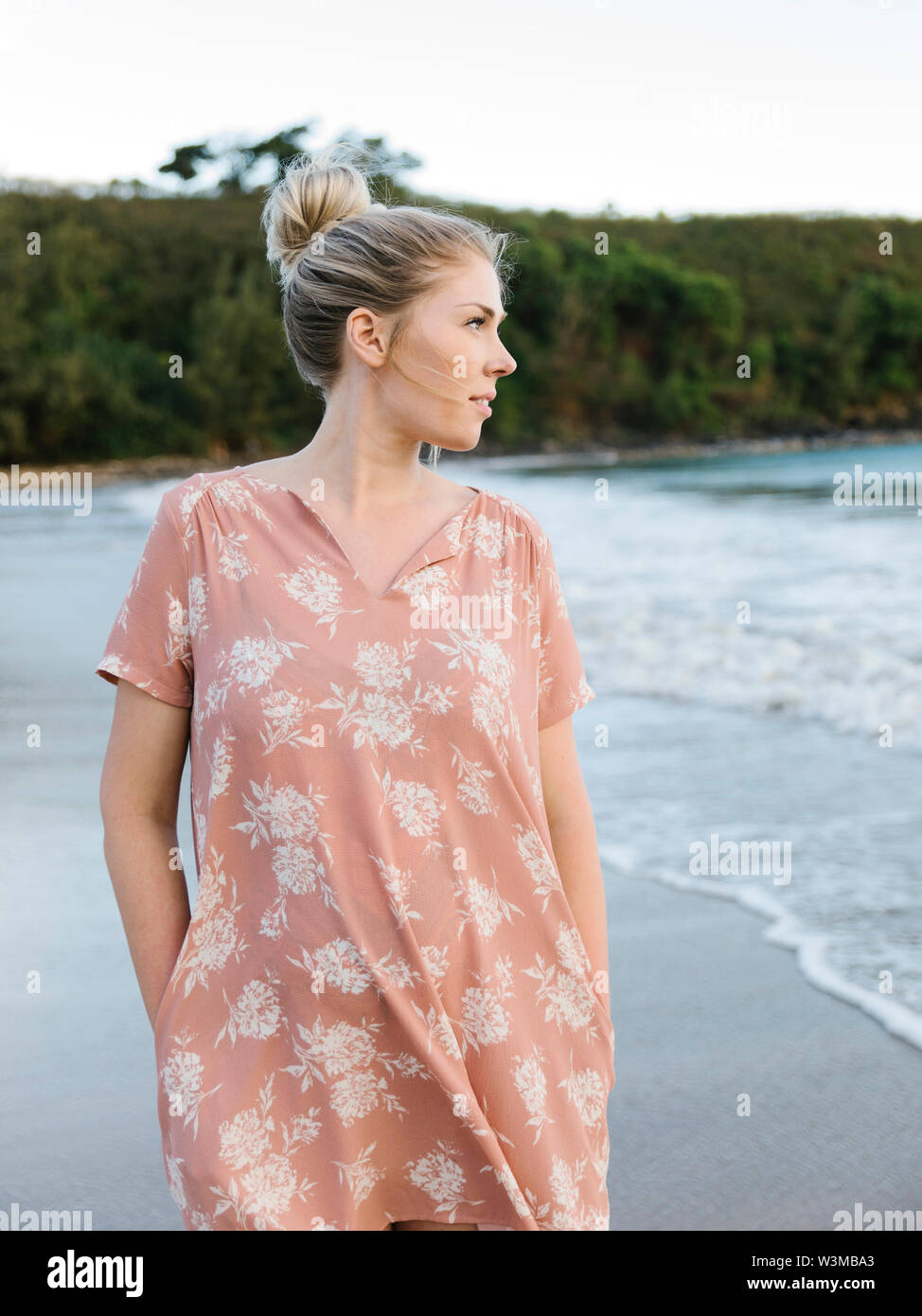 Woman in floral pattern dress at beach Stock Photo - Alamy