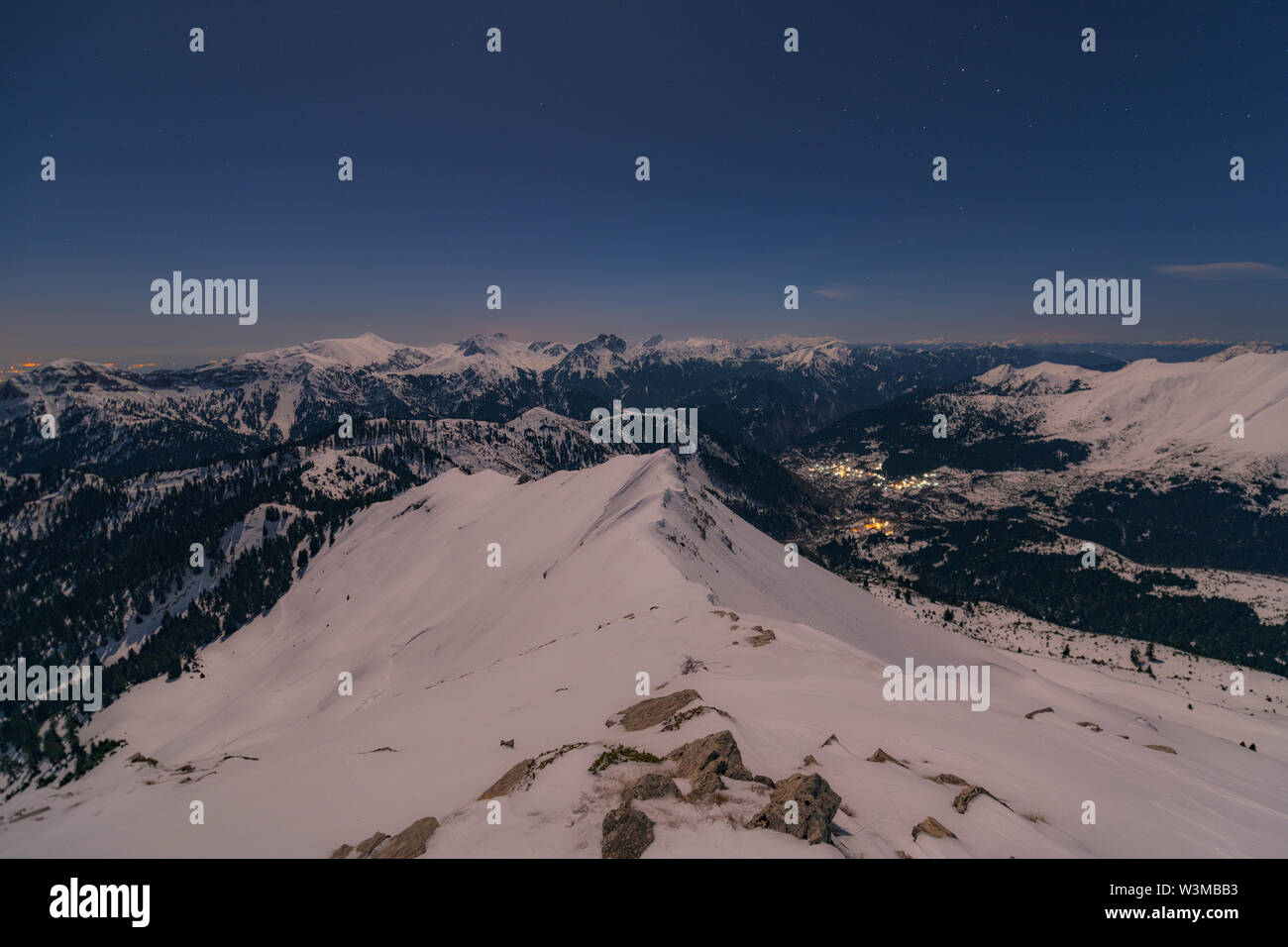 Moonlight on the edge of snowy Agrafa mountains Stock Photo - Alamy