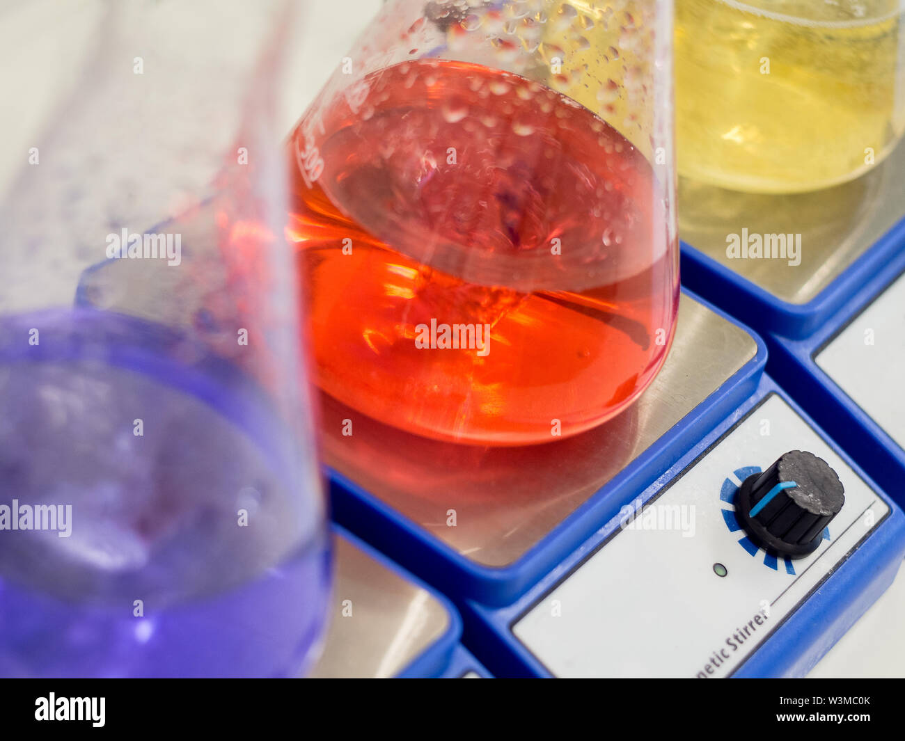 Erlenmeyer flasks with colorful solutions closeup Stock Photo - Alamy