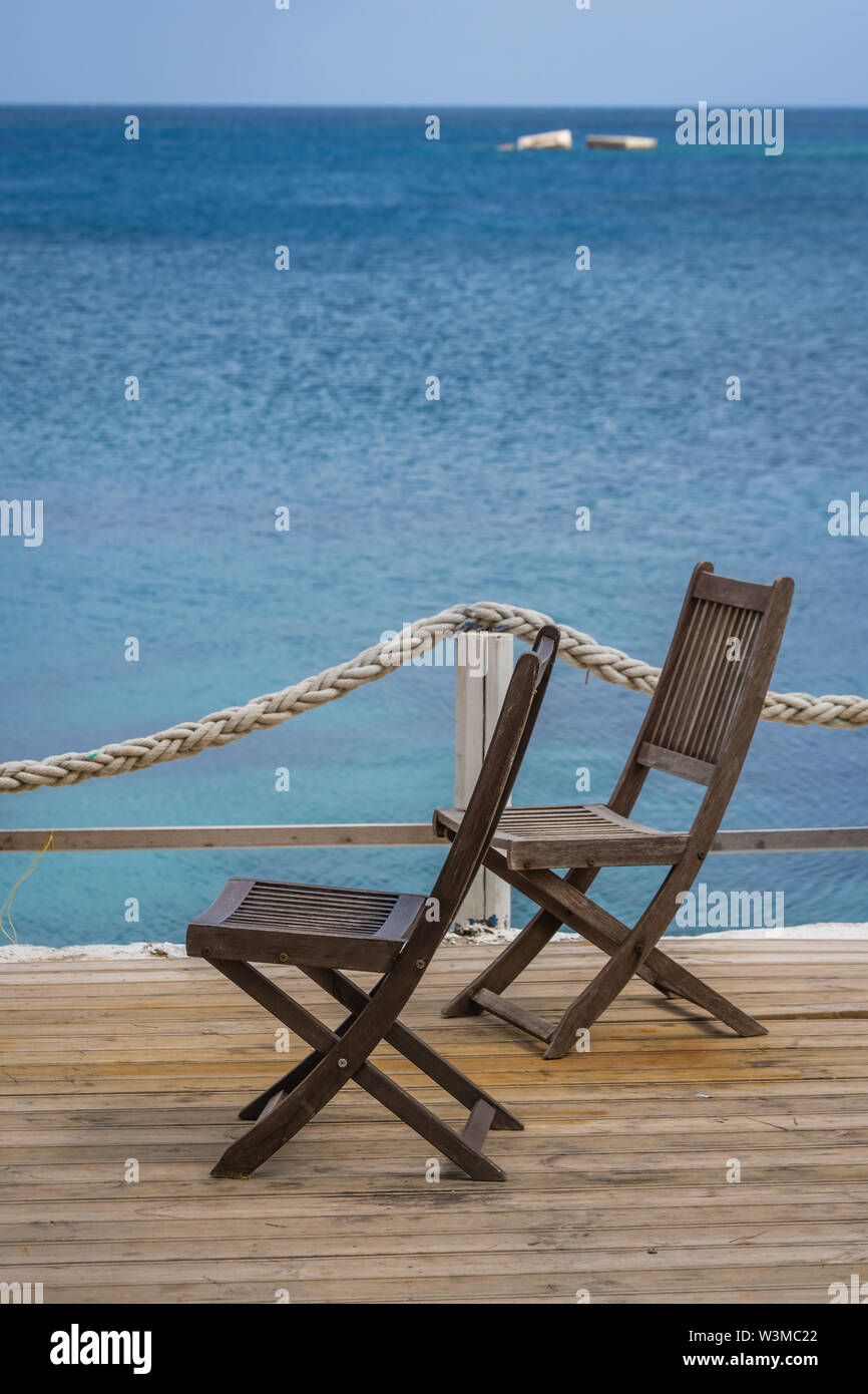 Wooden chairs on a deck platform in Agios Nikolaos beach on Zakynthos ...