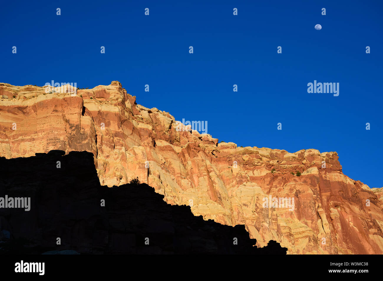 Moon over cliff in shadow in Capitol Reef National Park, USA Stock ...