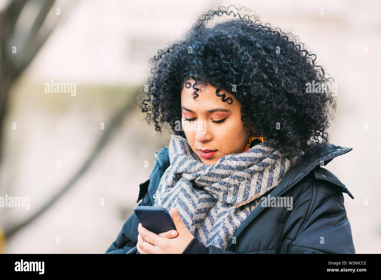 Young woman text messaging on smart phone Stock Photo - Alamy