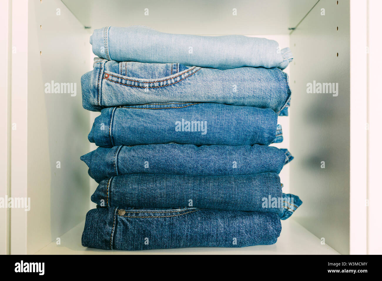 Stack of folded jeans Stock Photo - Alamy