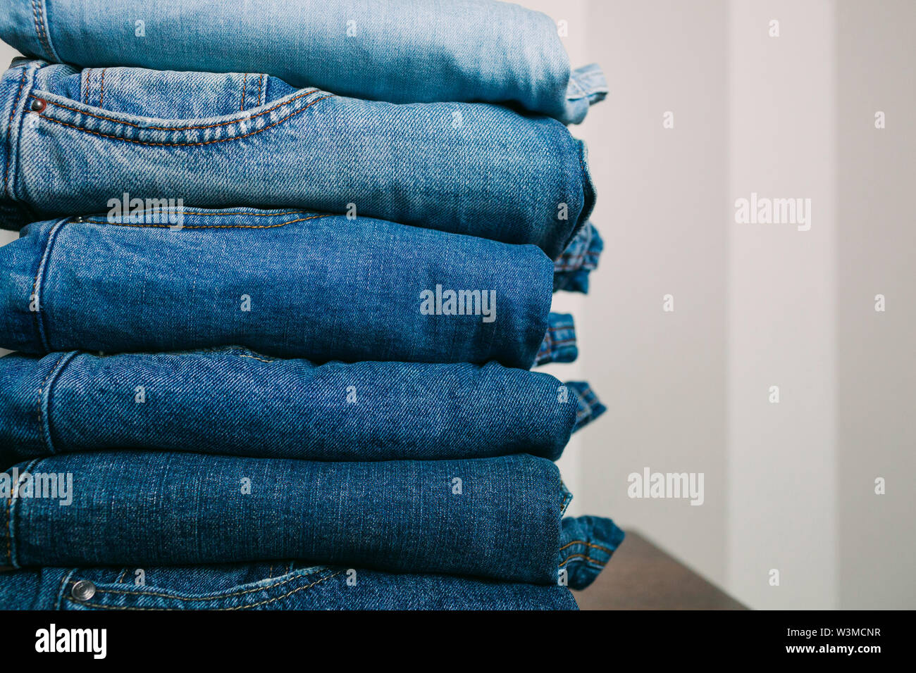 Stack of folded jeans Stock Photo - Alamy
