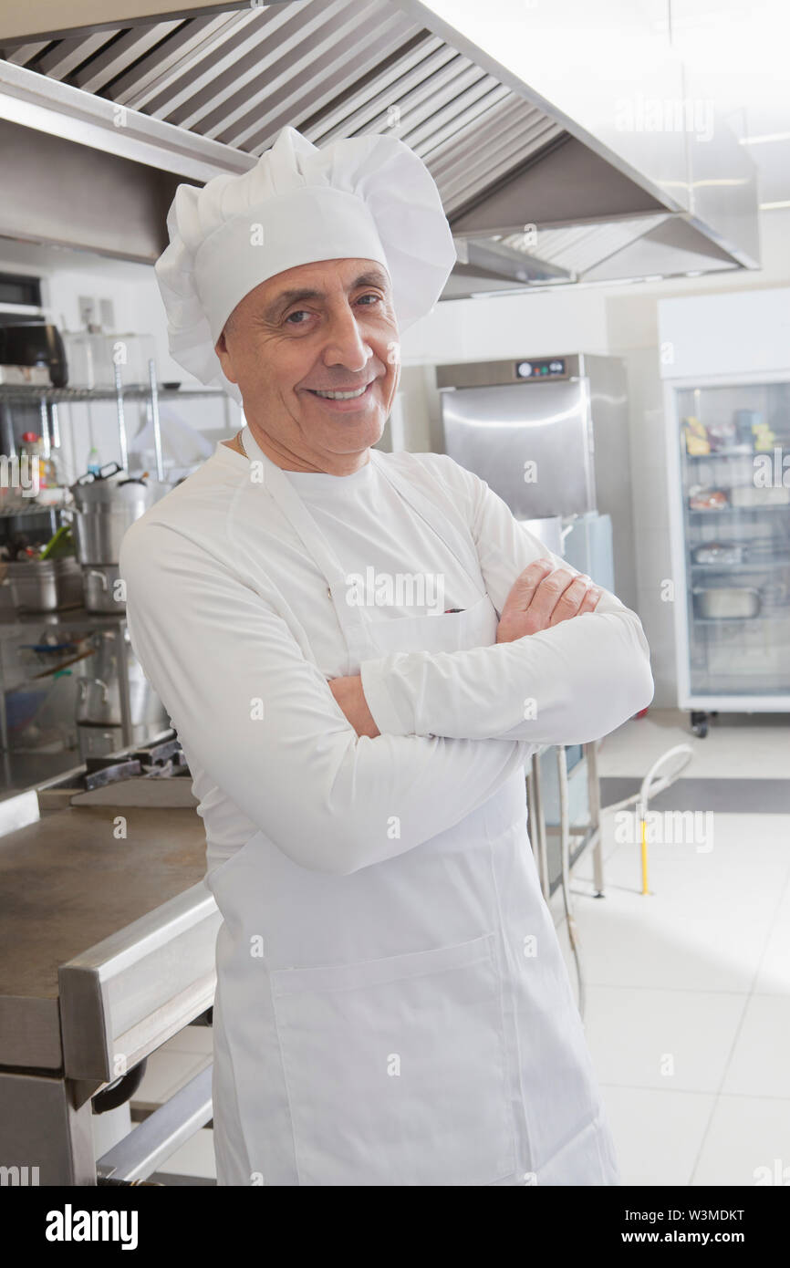 Chef smiling in commercial kitchen Stock Photo - Alamy