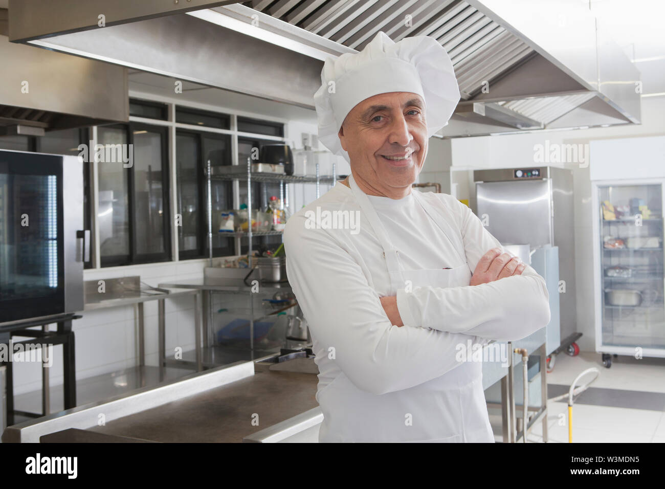 Chef smiling in commercial kitchen Stock Photo - Alamy