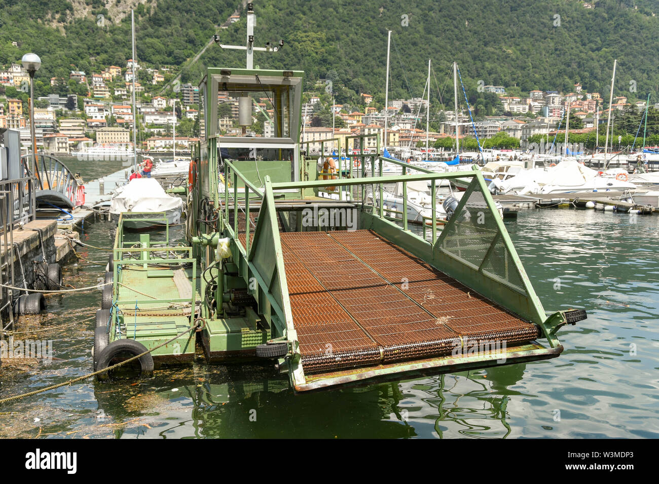 LAKE COMO, ITALY - JUNE 2019: Industrial barge with conveyor belt used ...
