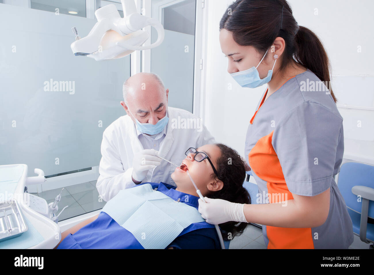 Teenage girl getting dental cleaning Stock Photo - Alamy