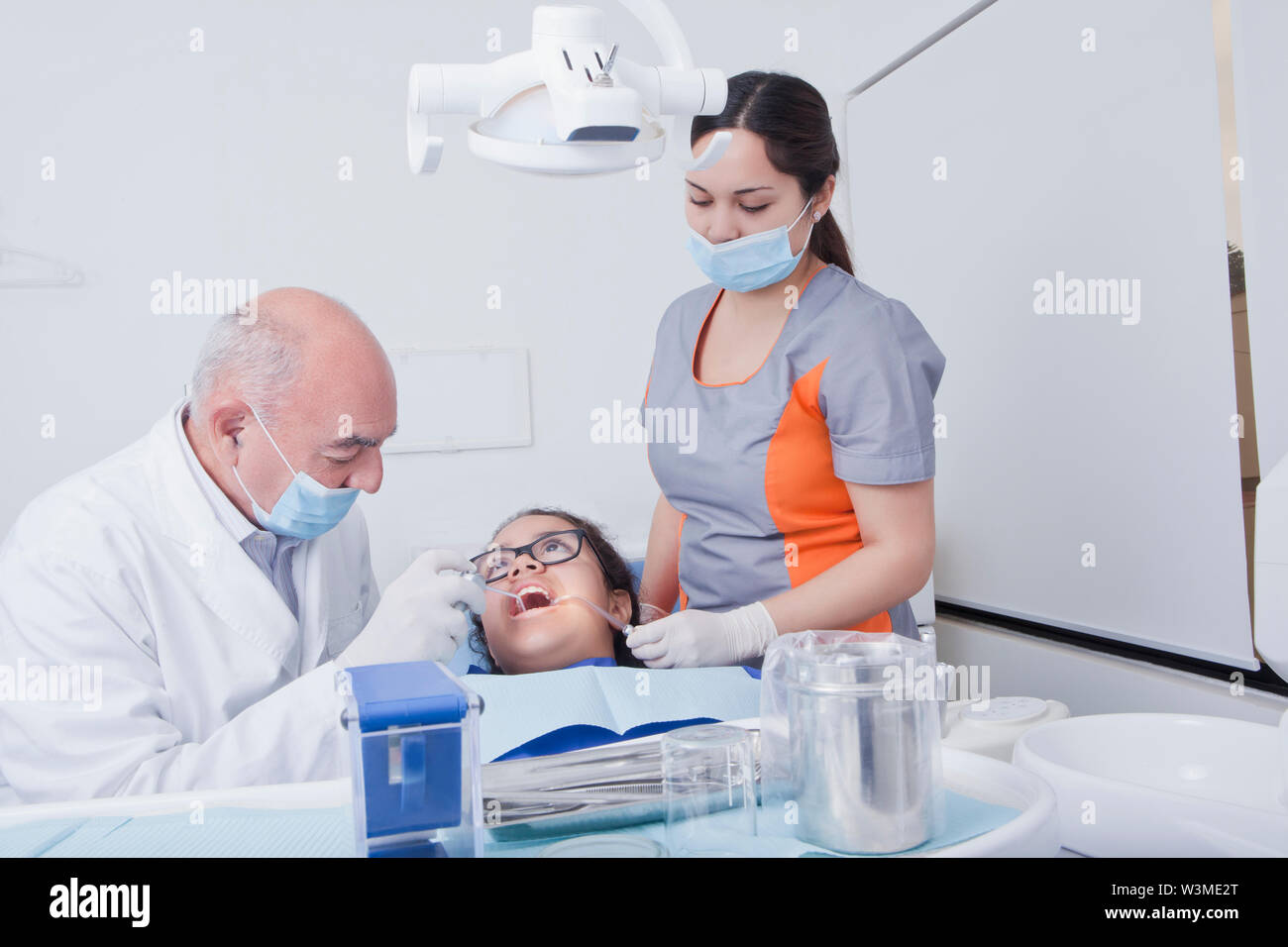 Teenage girl getting dental cleaning Stock Photo - Alamy