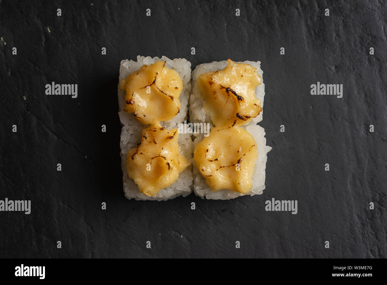 Sushi with burnt yellow sauce Stock Photo - Alamy