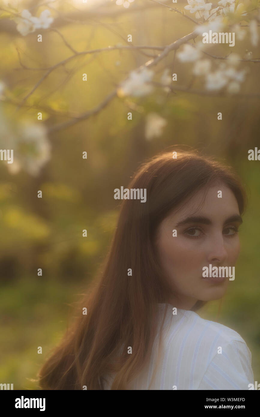 Young woman looking over her shoulder Stock Photo - Alamy