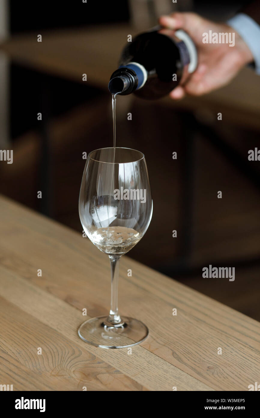 Waiter pouring wine restaurant table hi-res stock photography and ...