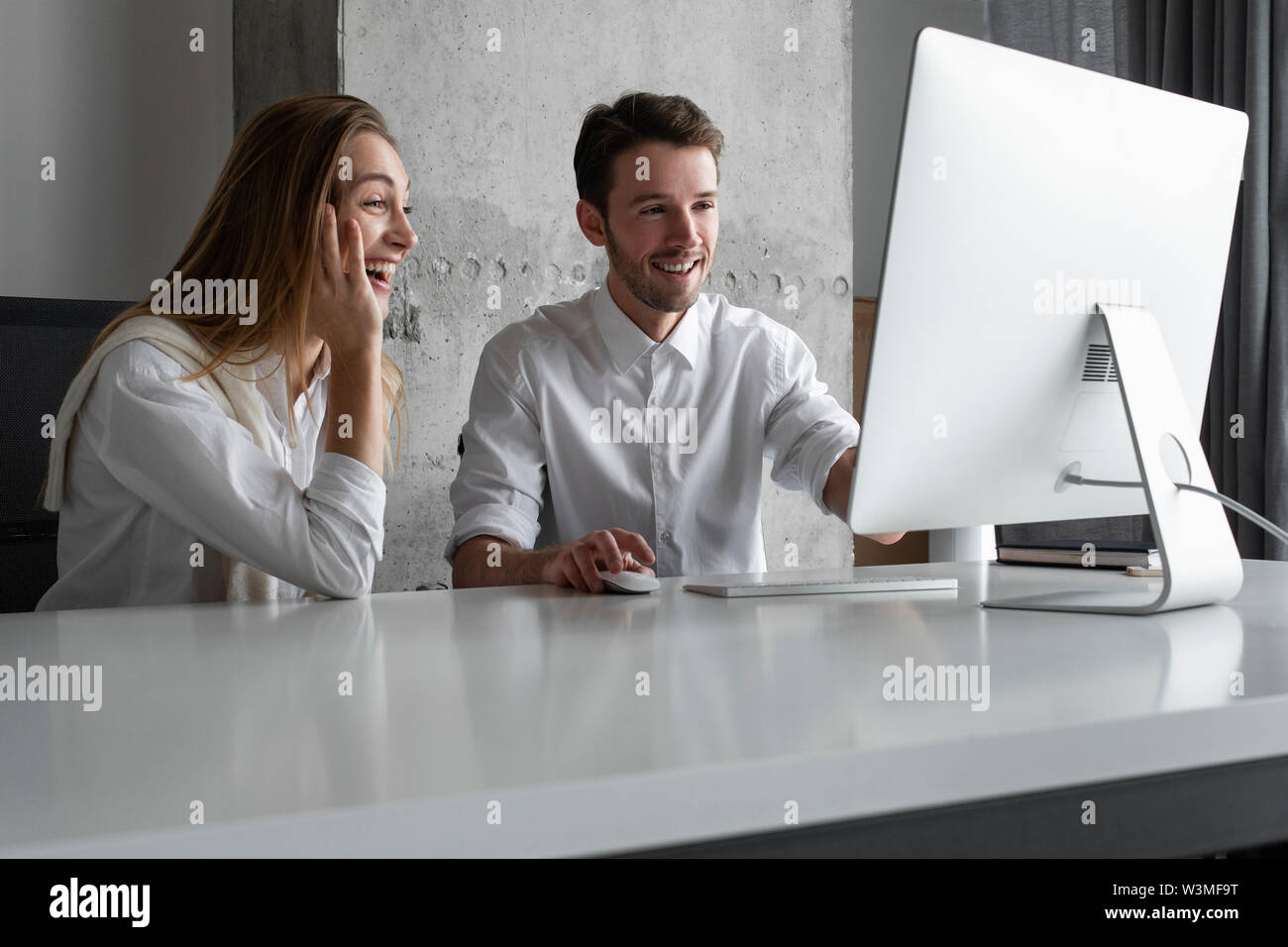 Businesspeople using computer together Stock Photo - Alamy