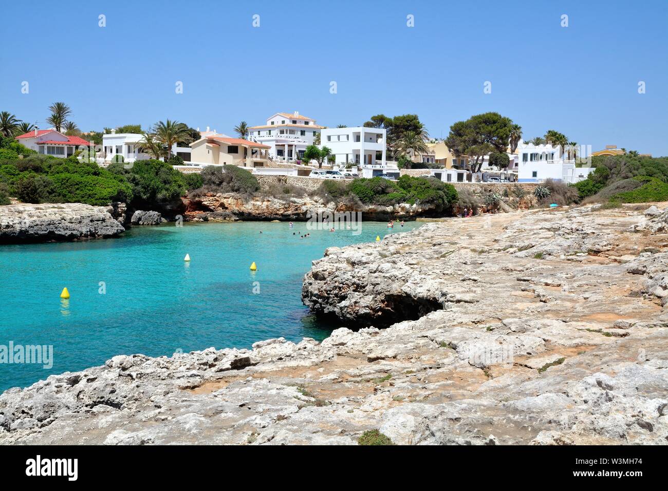 The beach and cove at Sa Caleta on a hot summers day,Cala Santandria ...