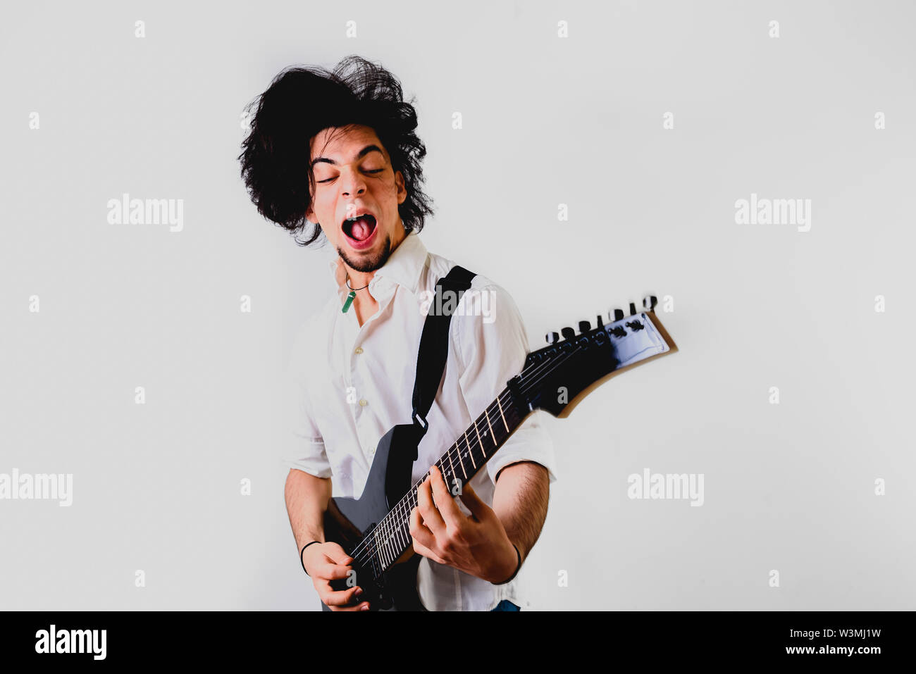 Portrait of young guitarist with gesture on his face Stock Photo - Alamy