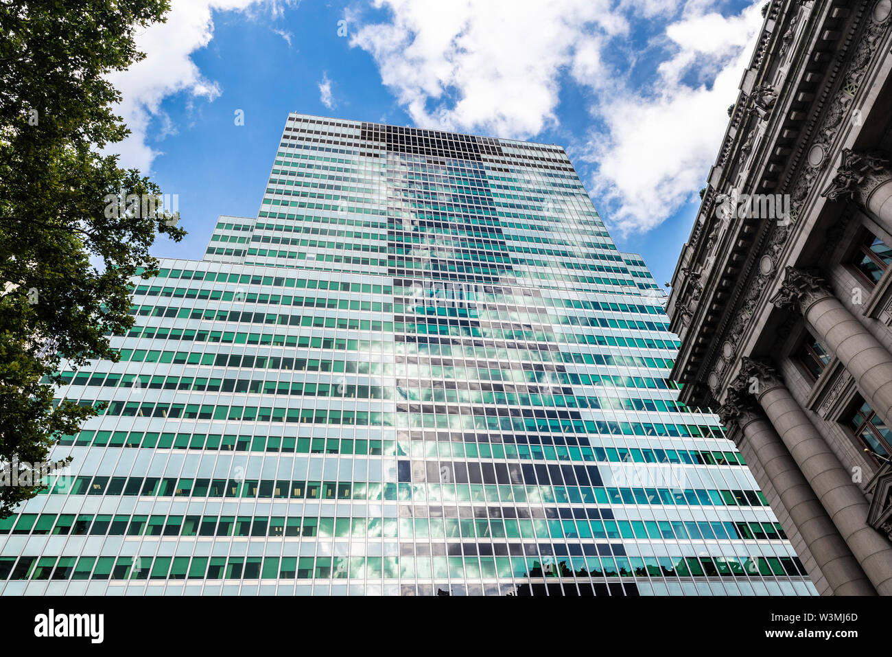 Low angle shot of modern skyscraper and classic building in Lower ...