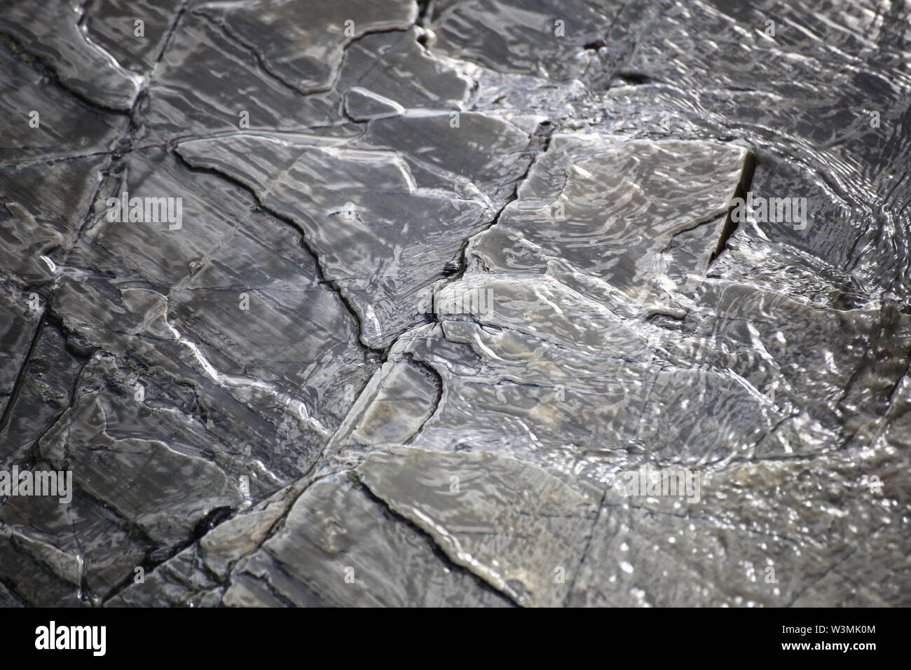 Slate surface with soft reflections of water Stock Photo - Alamy
