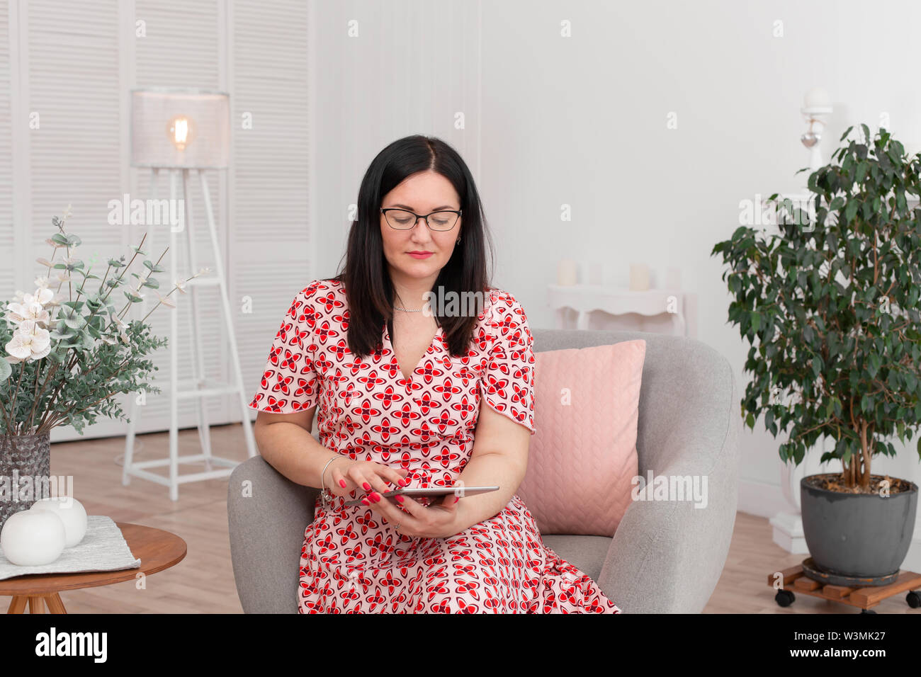 A professional doctor psychologist with glasses sits in a bright office ...