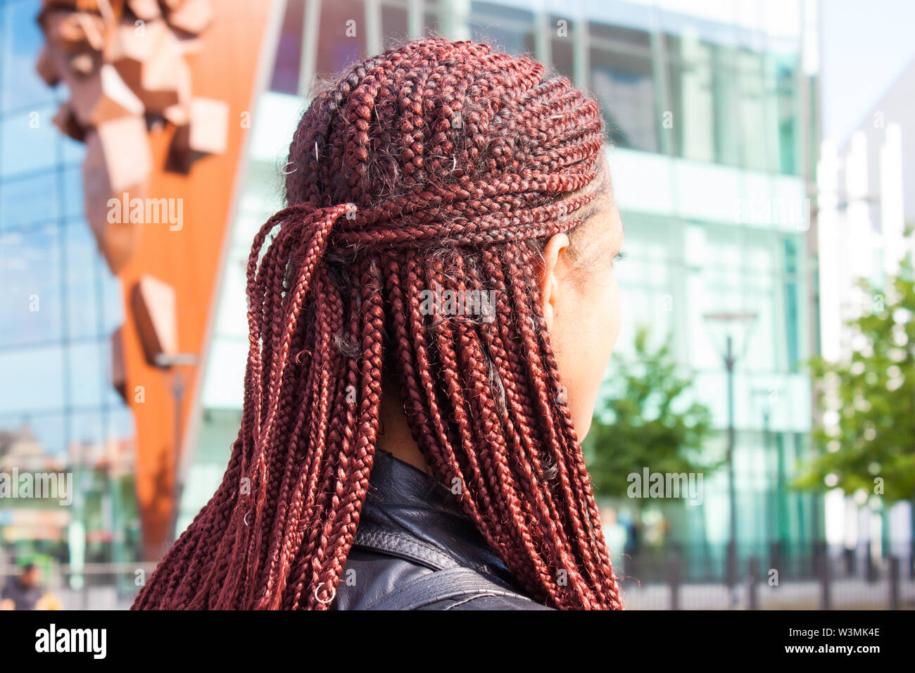 Girl with red braided hair style on street in summer Stock Photo - Alamy