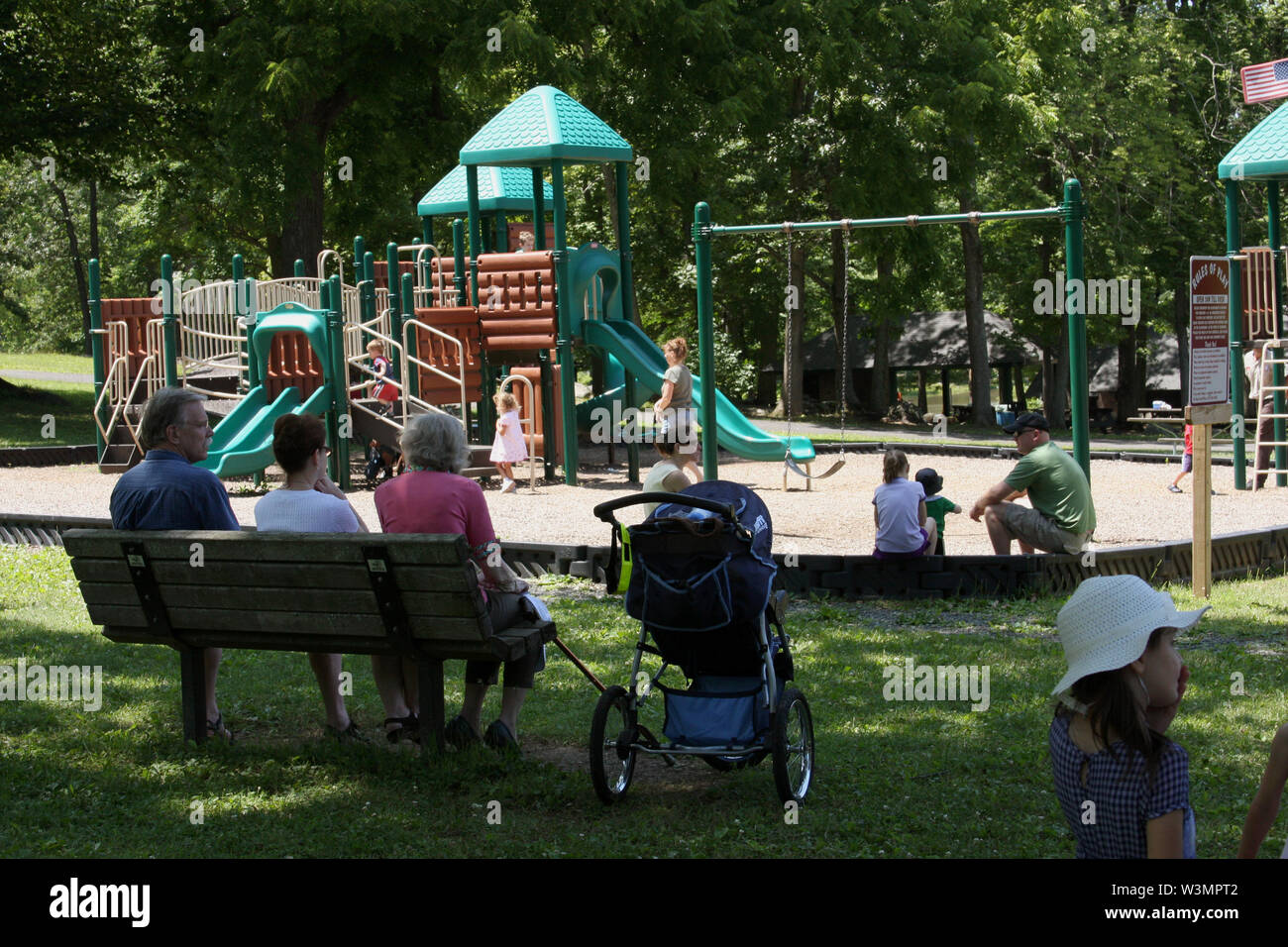 Parents supervising little kids at the playground Stock Photo - Alamy