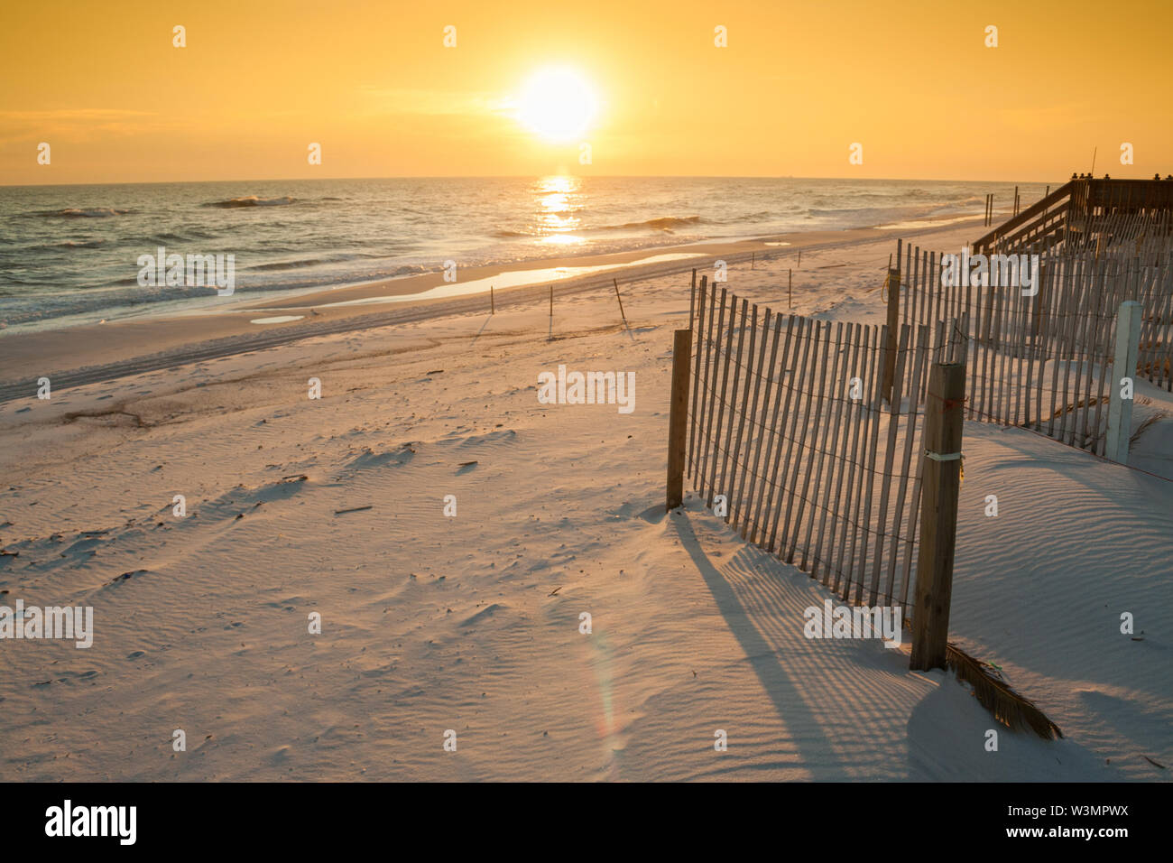 Beautiful Sunset Over the Ocean with Sand Fencing Stock Photo - Alamy