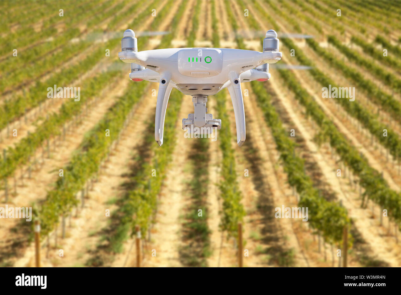 Unmanned Aircraft System (UAV) Quadcopter Drone In The Air Over Grape ...