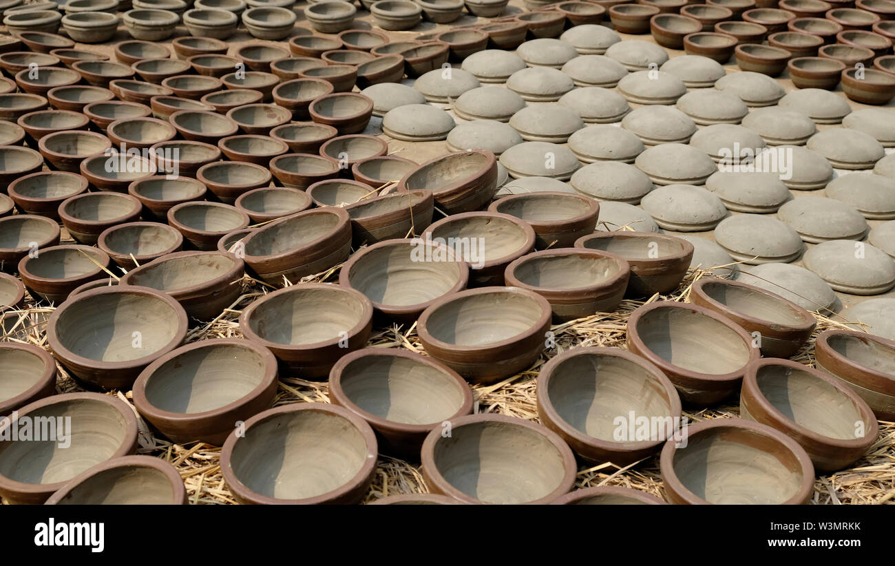 The finished clay pots are left to dry under the sun before they are ...