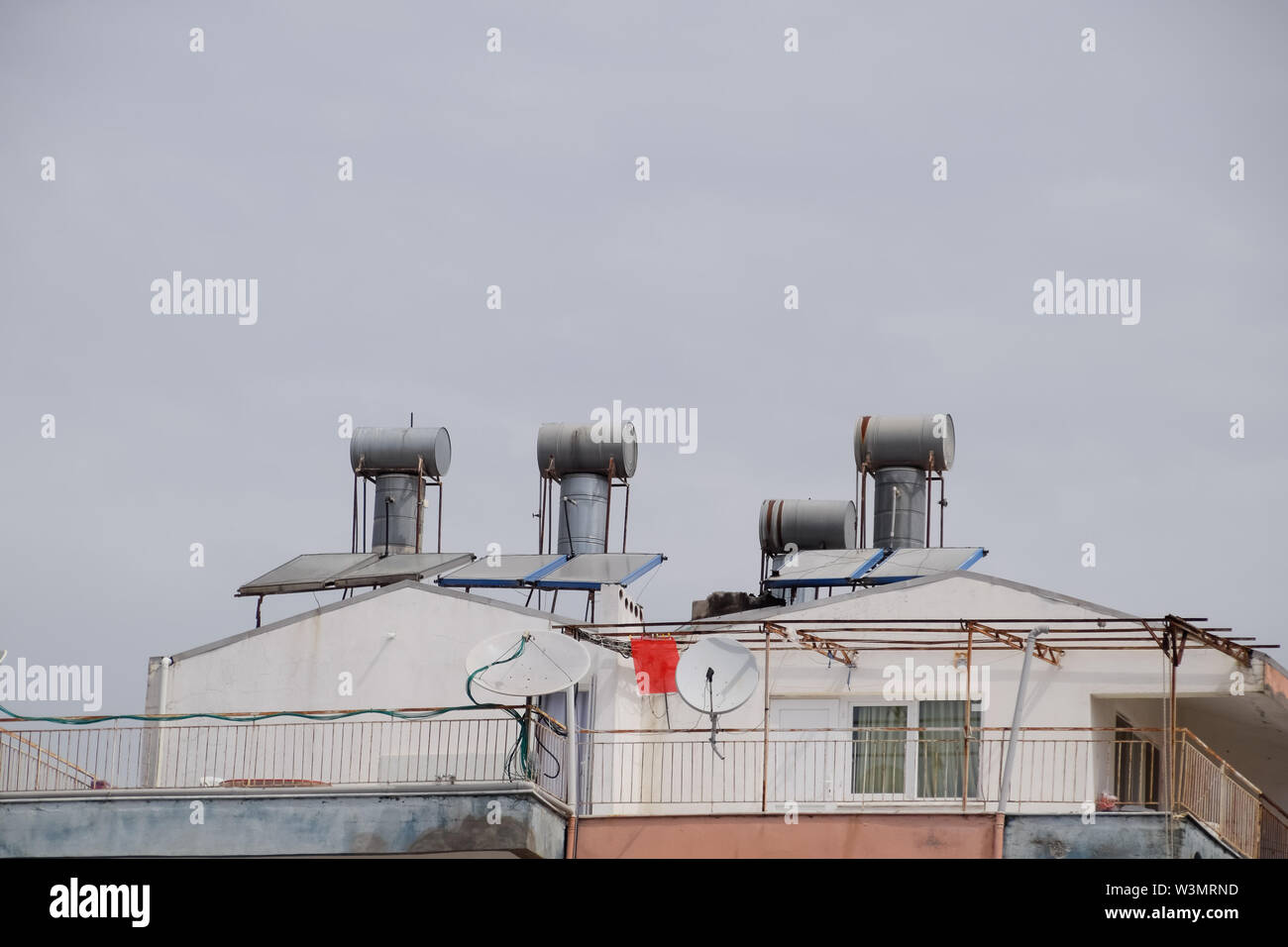 Steel barrels of boilers with water on the roof of a building to heat ...