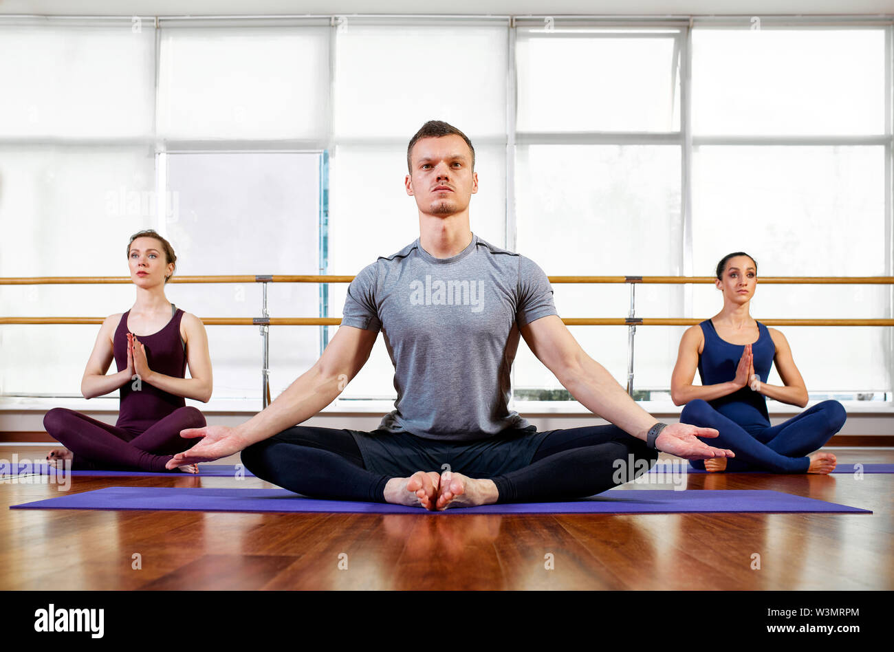 fitness, yoga and healthy lifestyle concept - group of people doing ...