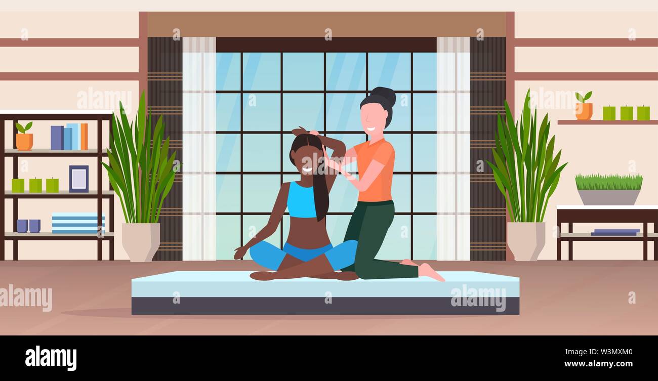 Personal Trainer Doing Stretching Exercises With African American Girl