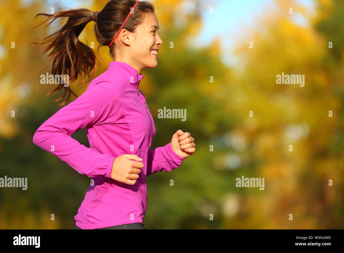 Woman running in autumn fall forest. Female runner training outdoor in ...