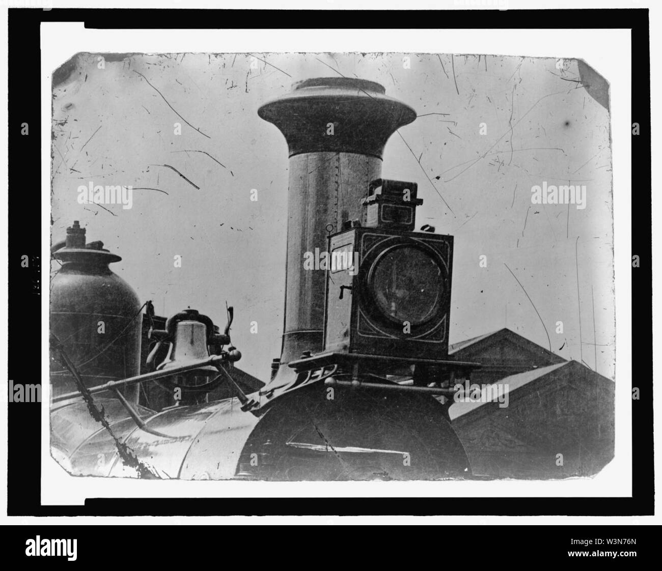Close up view of front of locomotive, showing light, smoke stack and ...