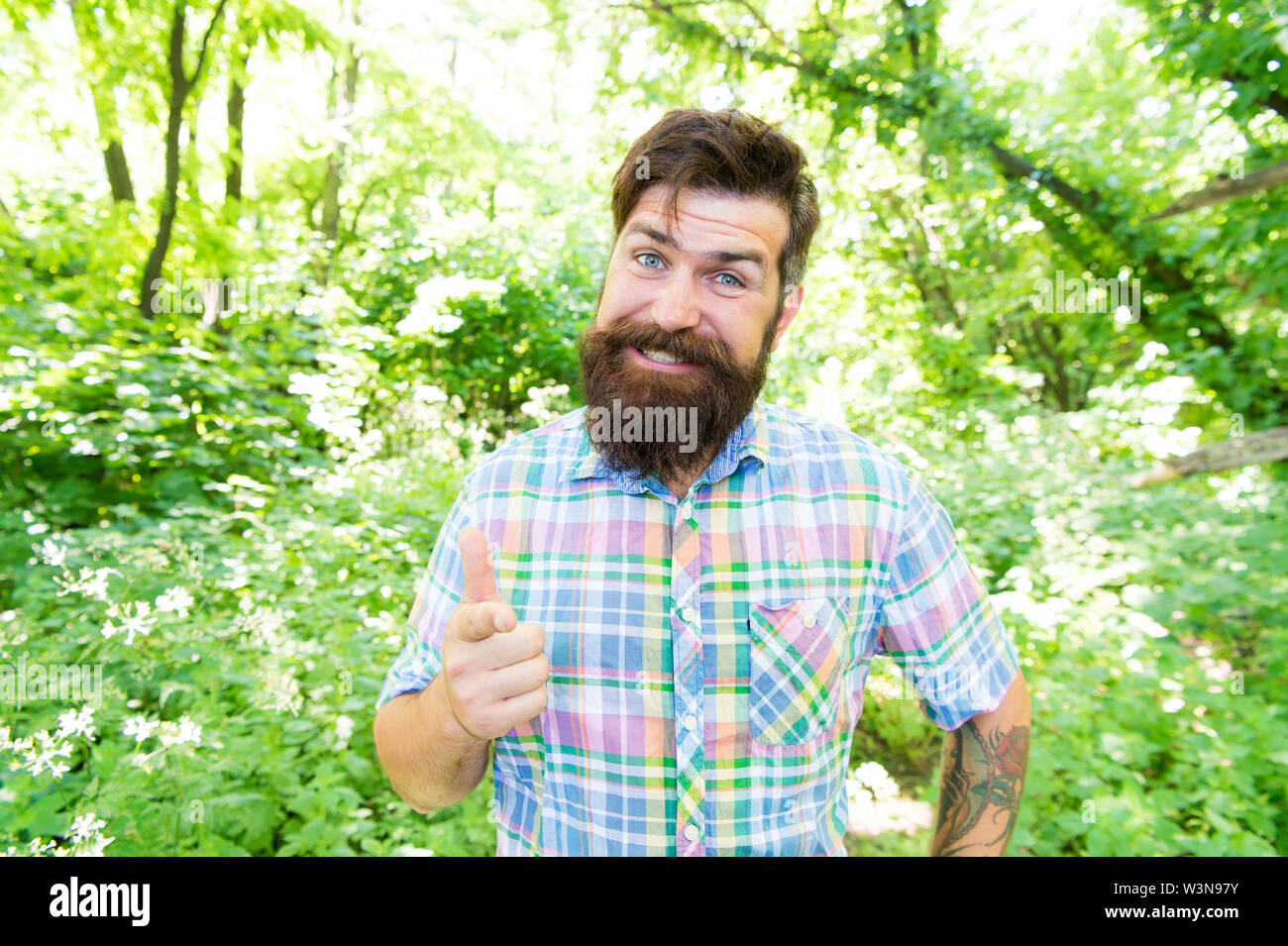 Man handsome beard and mustache in summer forest. United with environment. Summer vacation ...
